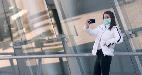Coronavirus - Outdoor portrait of young female in stylish outfit making ...