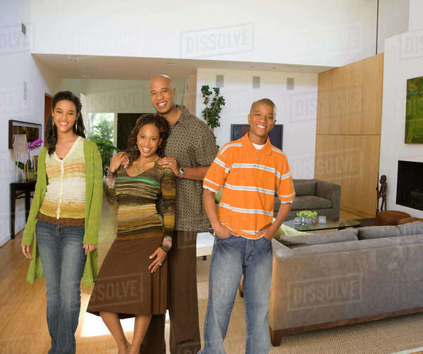 Family standing in living room together - Royalty-free Stock Photo ...