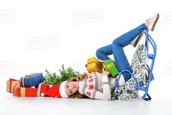 Beautiful Girl In Santa Hat Lying With Sledge Presents And Christmas