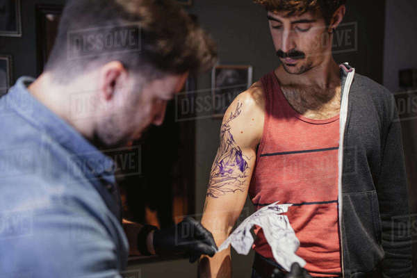 Tattoo Master Removing Template On Client s Forearm Stock Photo 