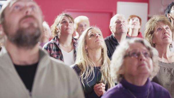 Informal contemporary church group of mixed age and race praying ...