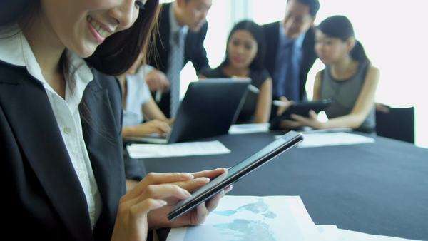 Close up young female Asian Chinese business manager foreground ...