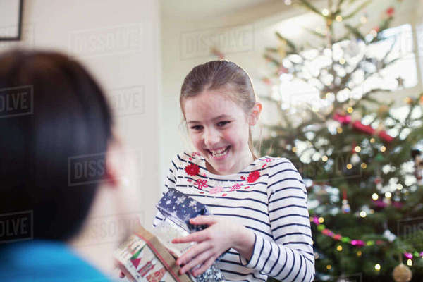 Happy, eager girl gathering Christmas gifts - Royalty-free Stock Photo ...