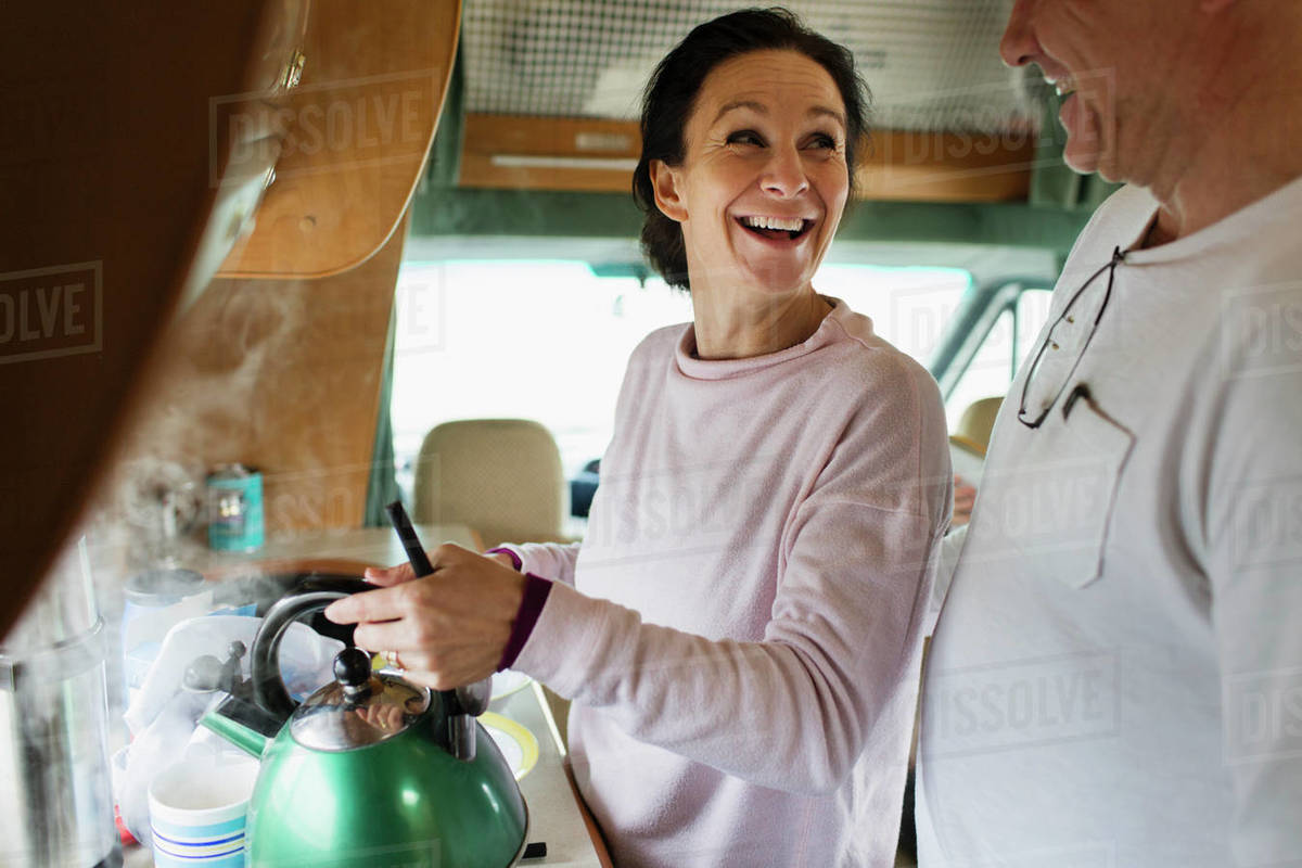 Couple making tea in motor home - Royalty-free Stock Photo | Dissolve