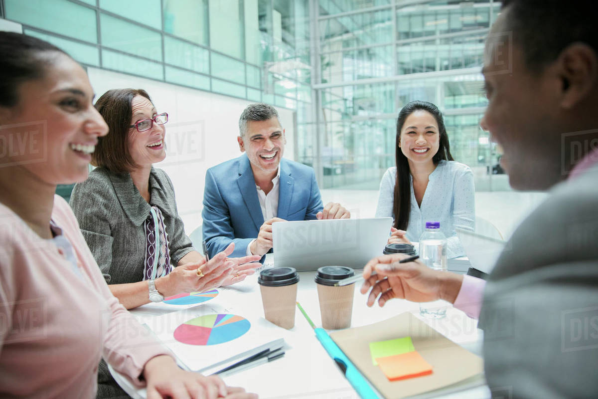 Happy business people laughing in meeting - Stock Photo - Dissolve