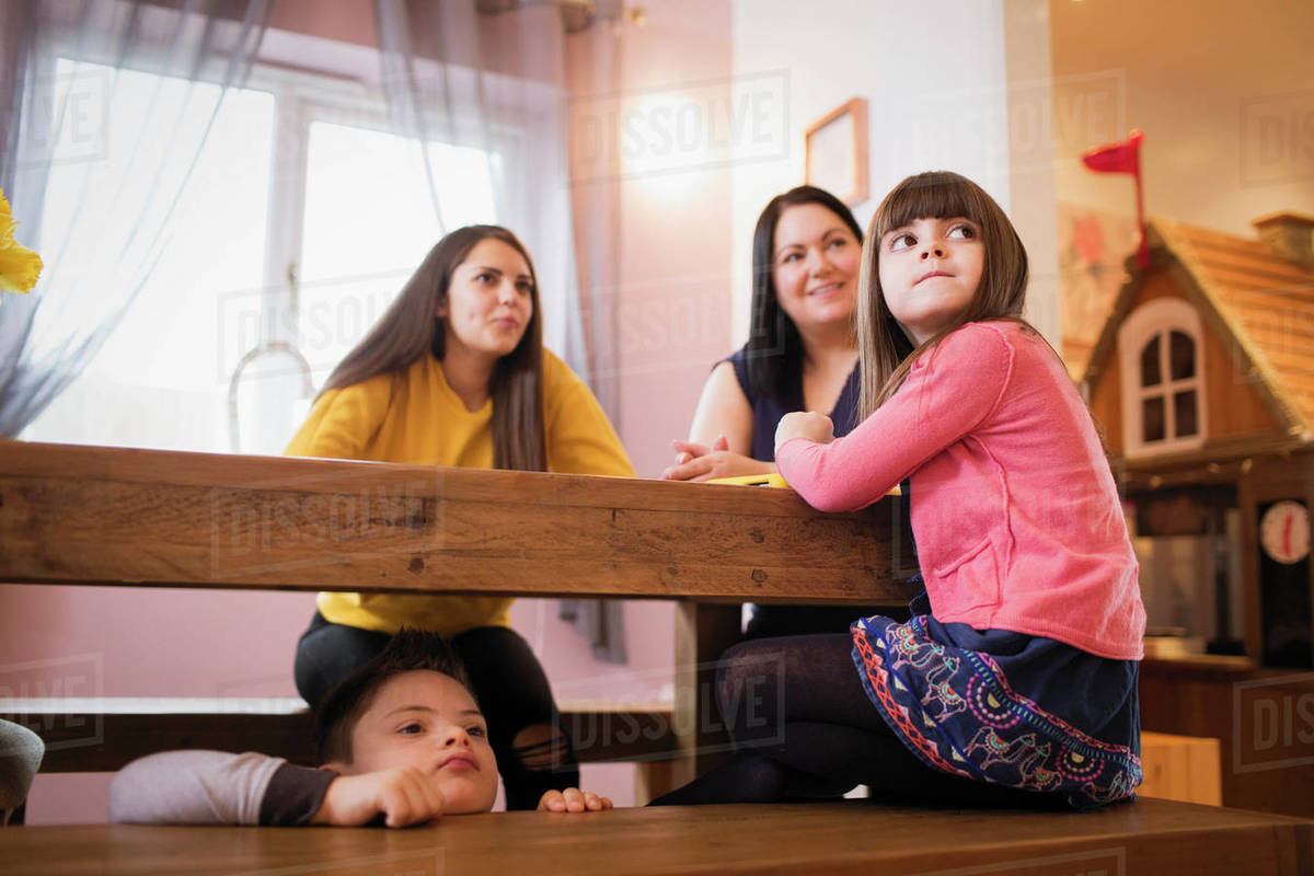 Family waiting at dining table - Stock Photo - Dissolve