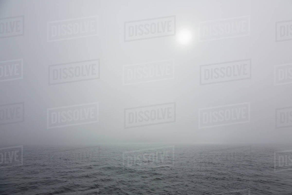 Thick gray fog over ethereal Atlantic Ocean - Stock Photo - Dissolve