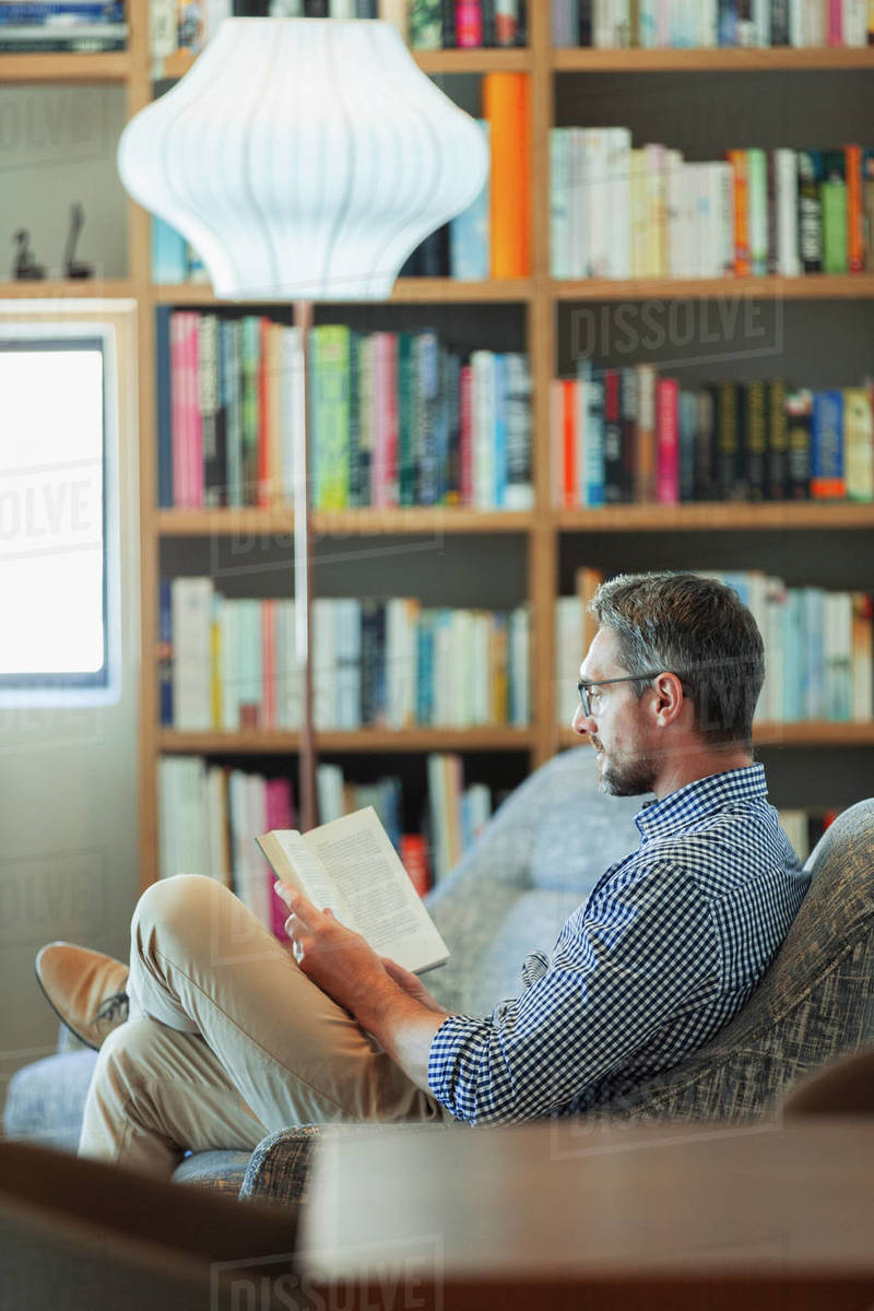 Man relaxing, reading book - Royalty-free Stock Photo | Dissolve