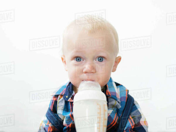 Studio shot of boy drinking from baby bottle - Royalty-free Stock Photo ...