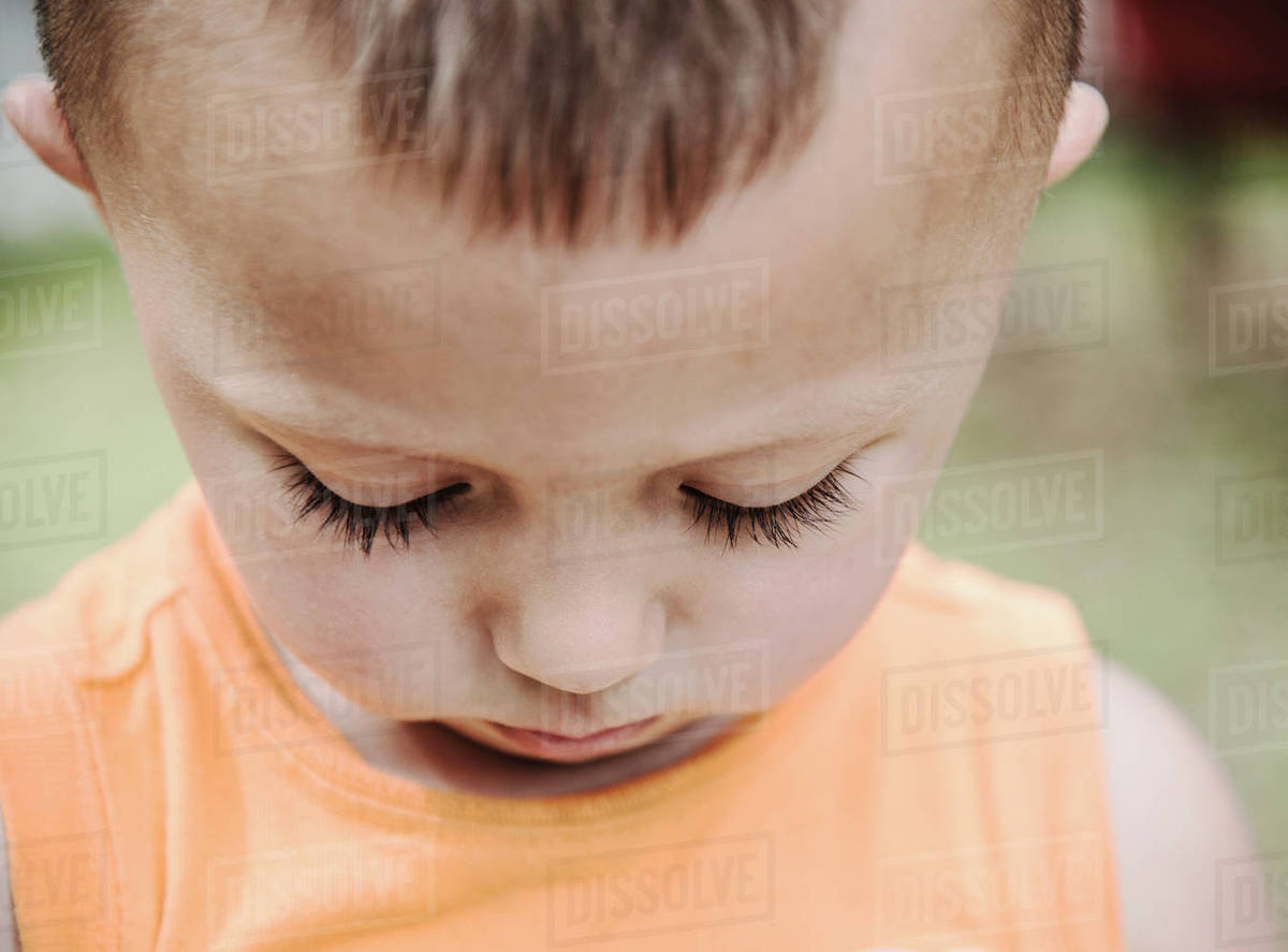 Boy looking down - Royalty-free Stock Photo | Dissolve