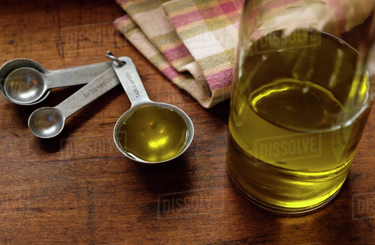 Measuring spoon, olive oil and napkin - Royalty-free Stock Photo | Dissolve