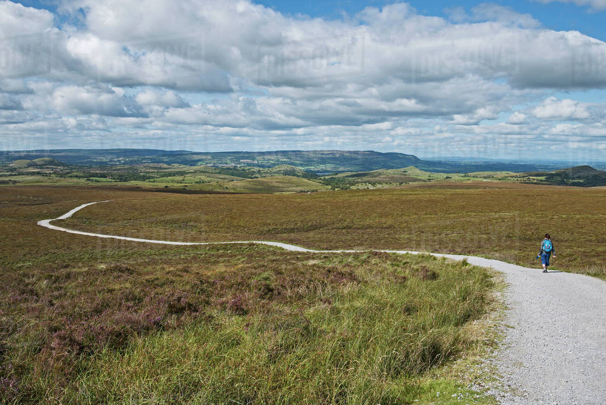 Ireland, Cavan County, Cuilcagh Mountain Park, Woman walking along ...
