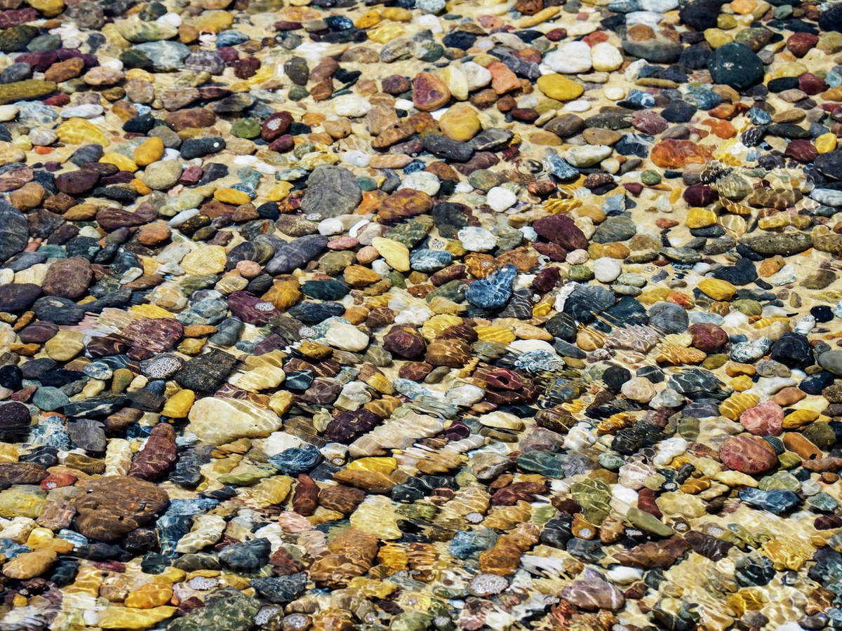 Colorful pebbles underwater - Stock Photo - Dissolve