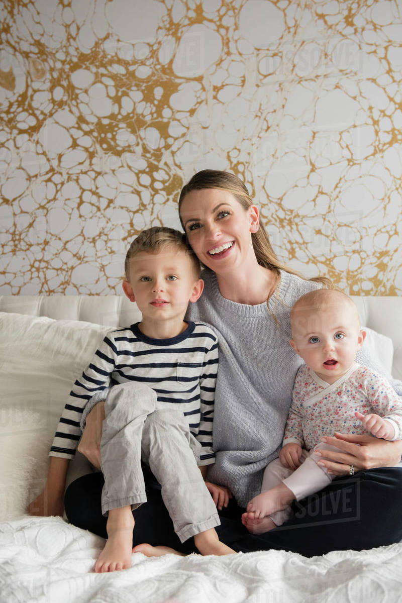 Portrait of happy mother of two children (18-23 months, 4-5) - Stock ...