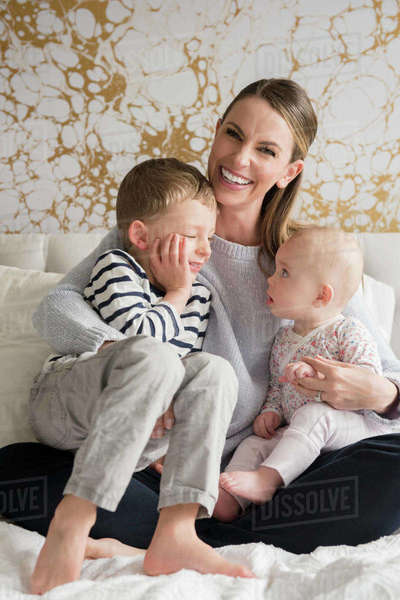 Portrait of happy mother of two children (18-23 months, 4-5) - Royalty ...