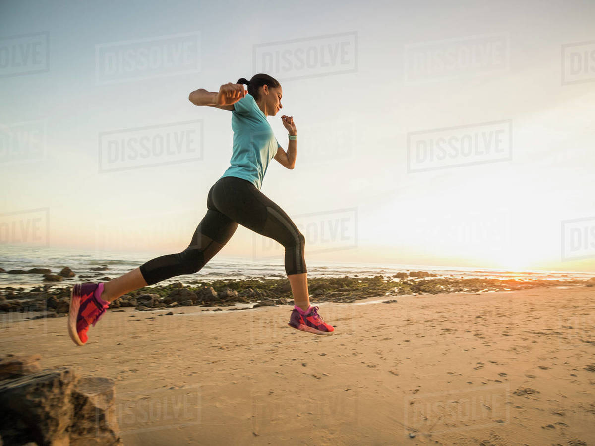 USA, California, Newport Beach, Woman jogging on beach - Royalty-free ...