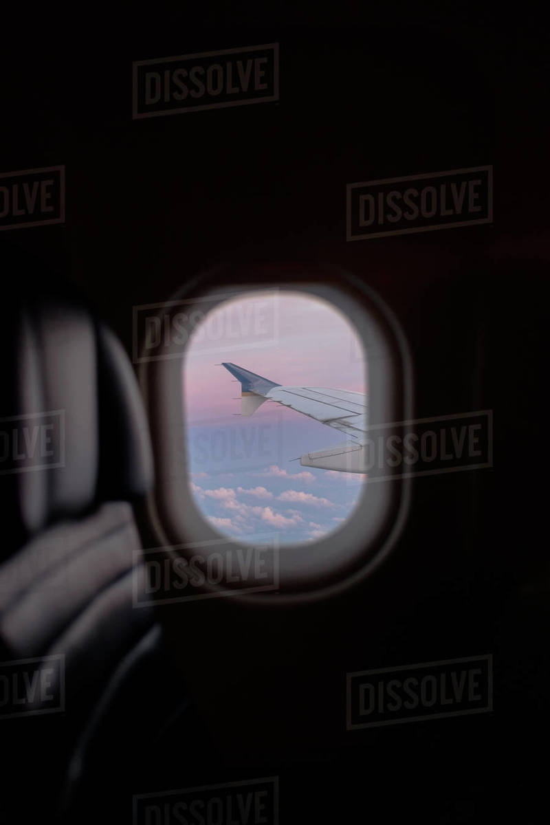 Airplane window in flight - Stock Photo - Dissolve