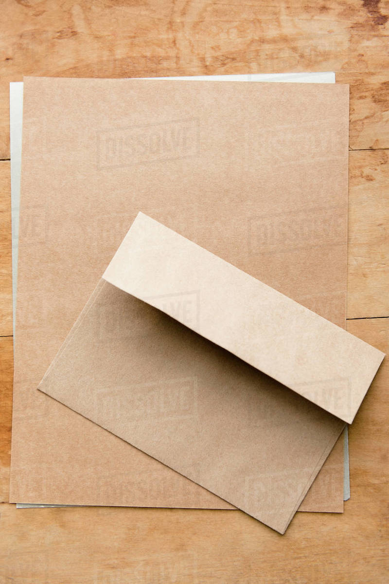 Envelope and paper on wooden table - Stock Photo - Dissolve