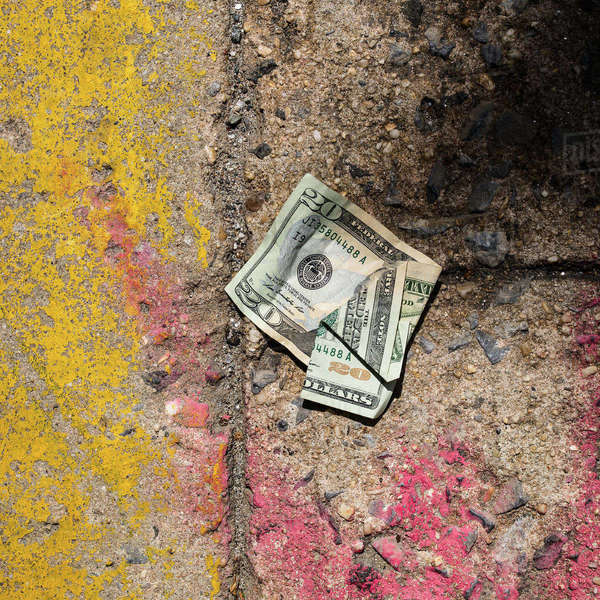 Crumpled money on sidewalk - Royalty-free Stock Photo | Dissolve