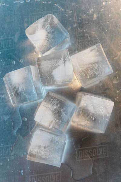 Ice cubes on silver surface - Stock Photo - Dissolve