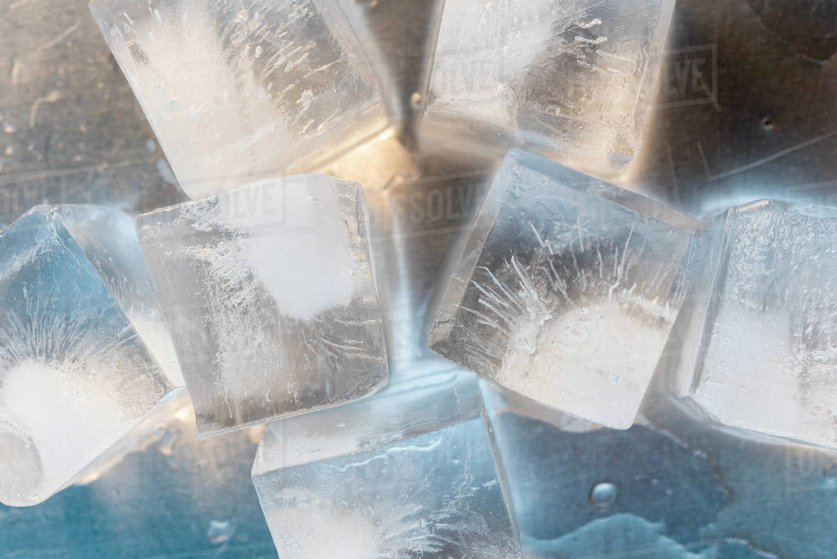 Ice cubes on silver surface - Royalty-free Stock Photo | Dissolve