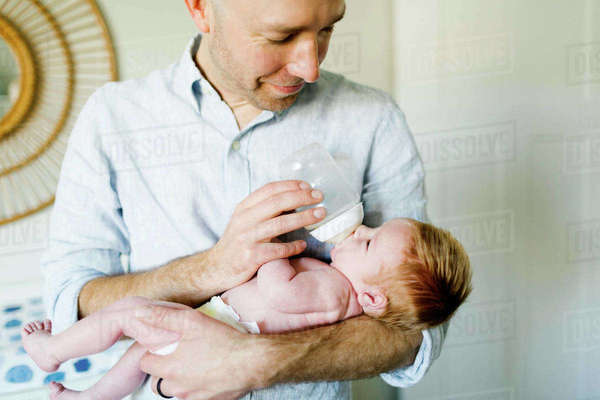 Man feeding his baby son - Royalty-free Stock Photo | Dissolve