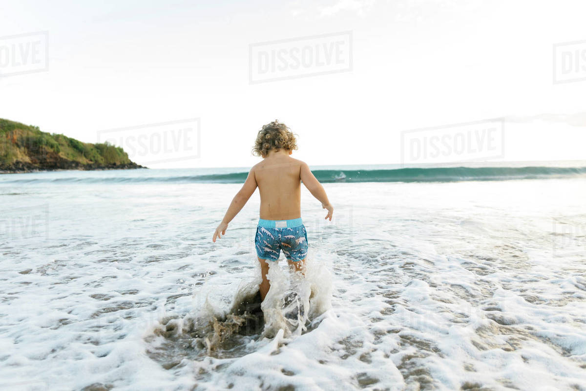 Boy playing on beach - Royalty-free Stock Photo | Dissolve
