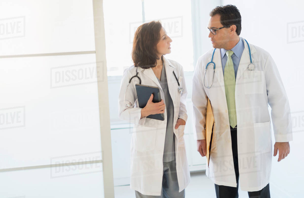 Two doctors talking in hospital - Royalty-free Stock Photo | Dissolve