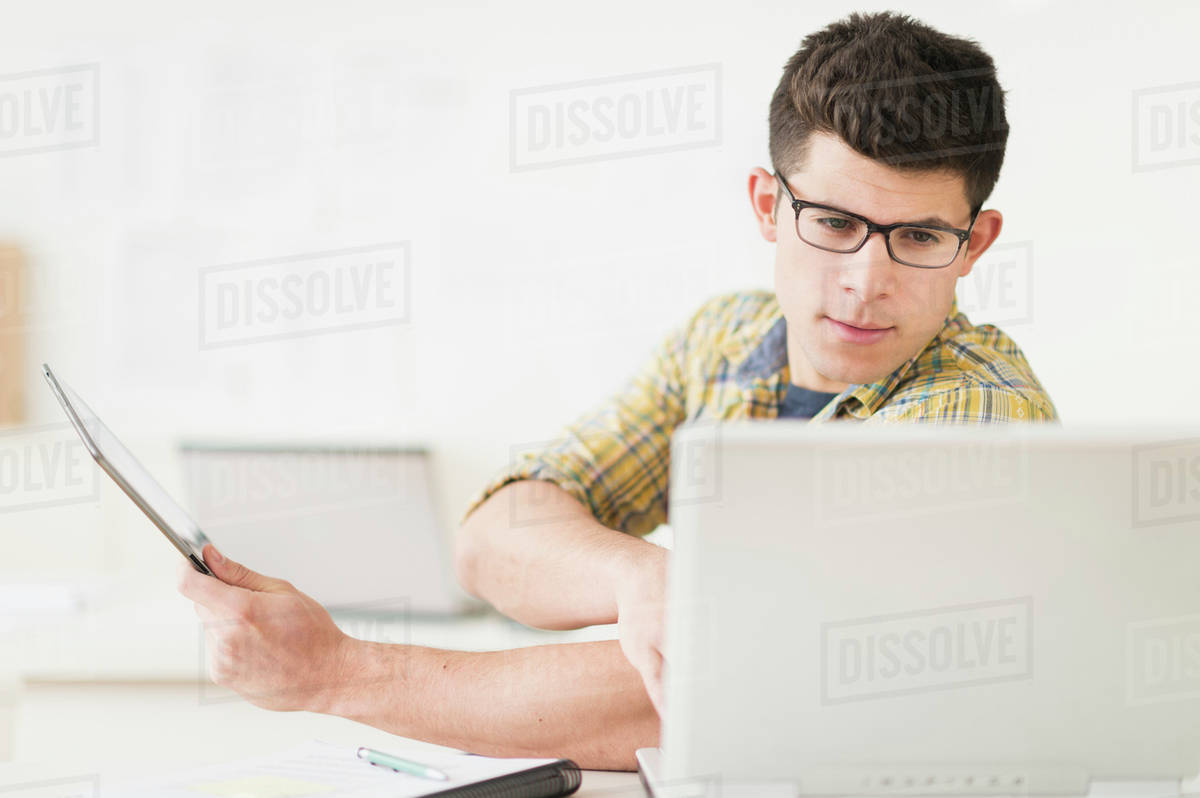 Young man using tablet - Royalty-free Stock Photo | Dissolve