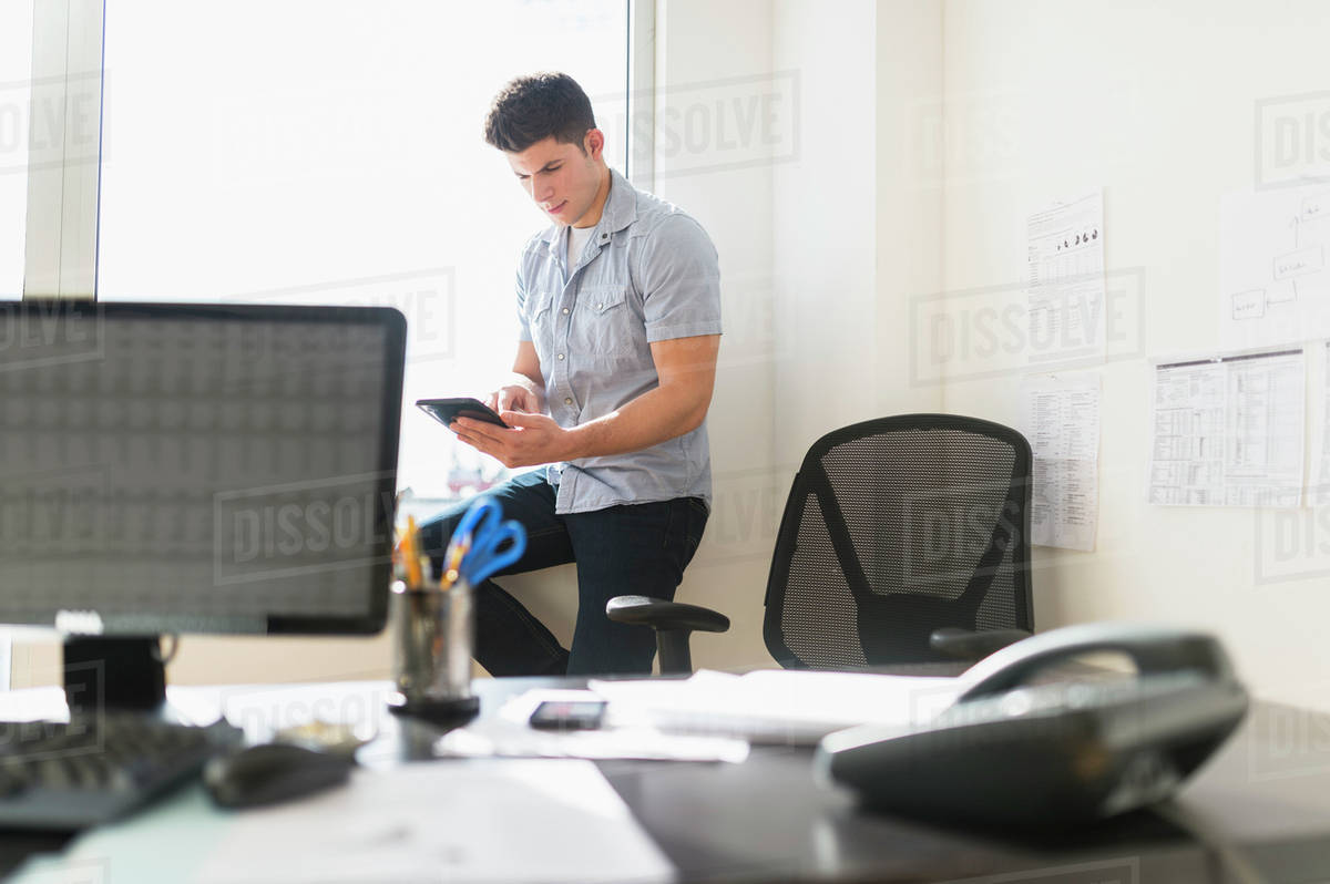 Young man using tablet - Royalty-free Stock Photo | Dissolve