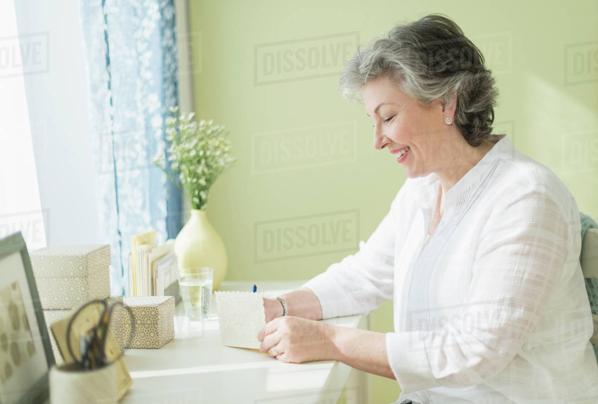 Mature woman writing letter - Stock Photo - Dissolve