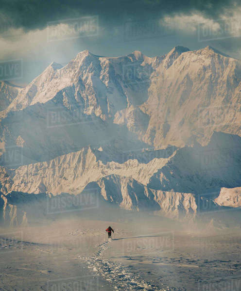 Man hiking through snow by mountain in Alpe Devero, Italy - Stock Photo ...