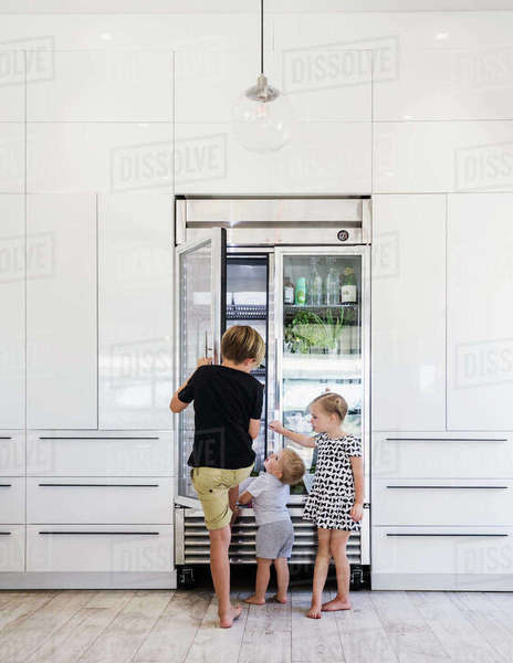 Children opening refrigerator - Royalty-free Stock Photo | Dissolve