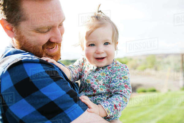 Father and baby girl smiling - Royalty-free Stock Photo | Dissolve