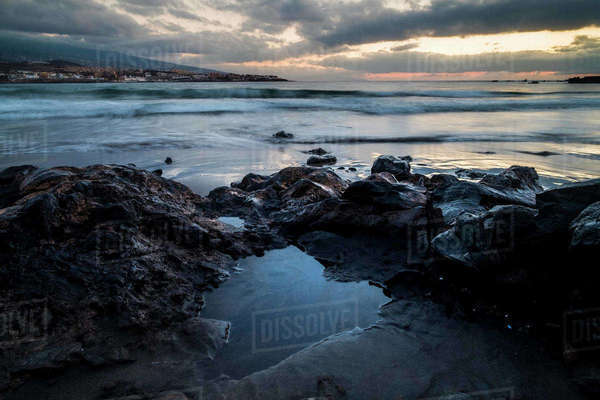 Rocks on beach at sunset in Tenerife, Spain - Stock Photo - Dissolve
