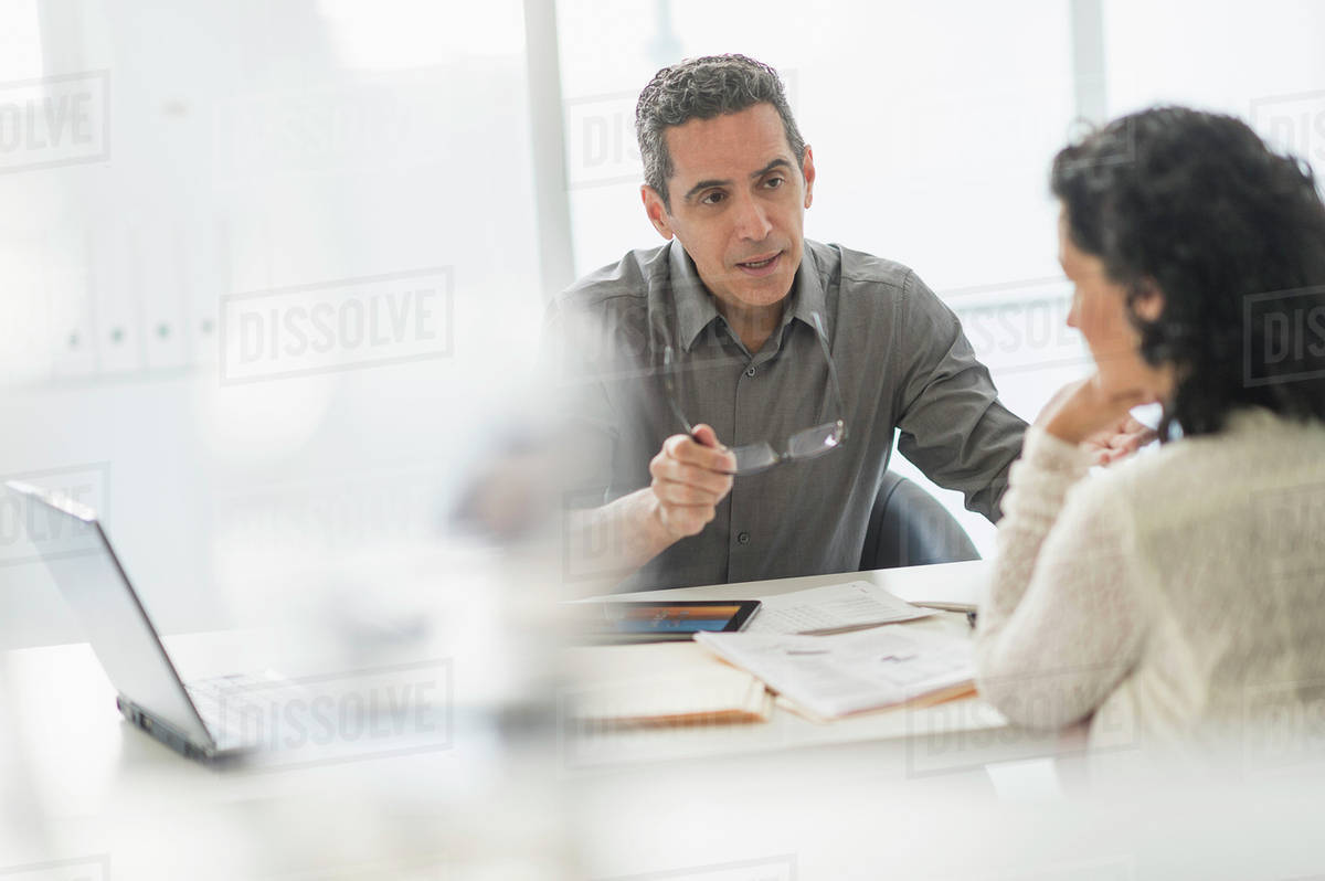 Business people talking at desk in office - Royalty-free Stock Photo ...