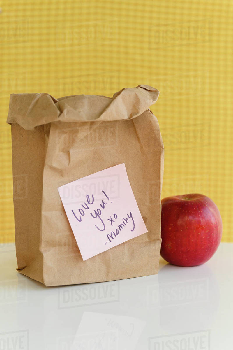School lunch in paper bag with note from mom - Stock Photo - Dissolve