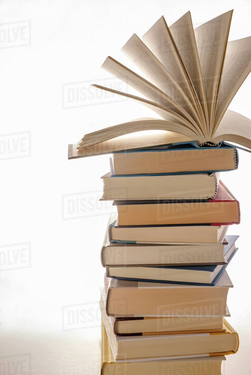 Open book on top of stacked books - Royalty-free Stock Photo | Dissolve