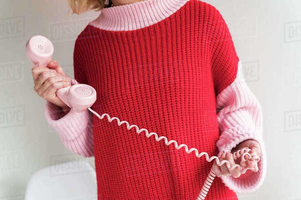 Woman holding vintage phone receiver with twisted cable - Royalty-free ...