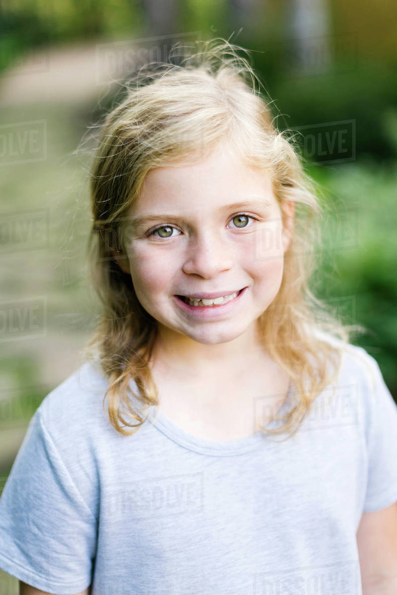 Portrait of smiling girl (8-9) - Royalty-free Stock Photo | Dissolve