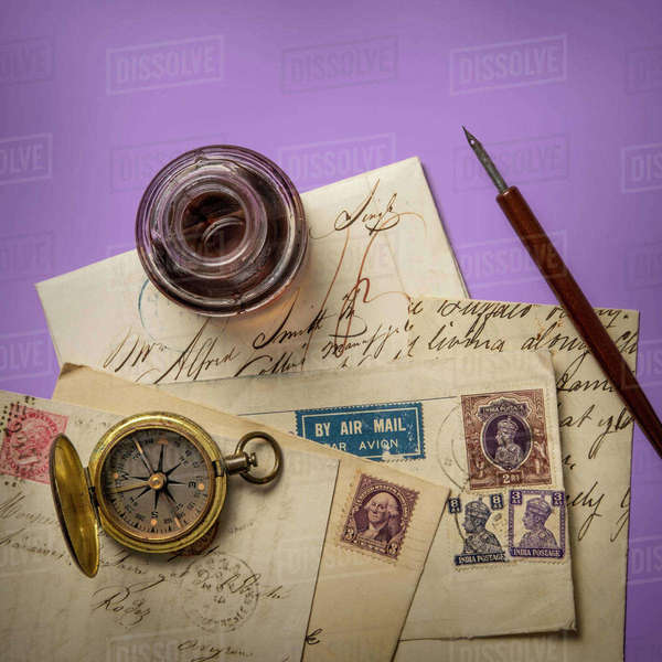 Antique ink well and old letters on purple background - Stock Photo ...