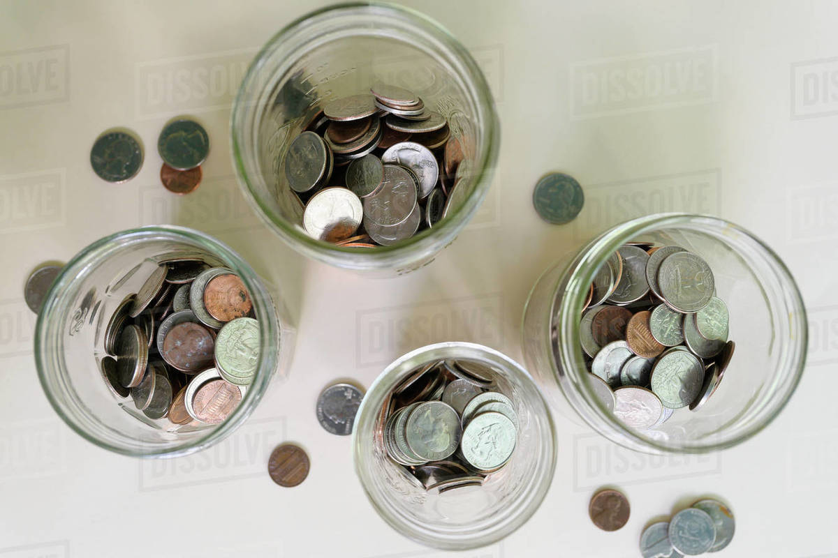 Jars with money on white background - Stock Photo - Dissolve