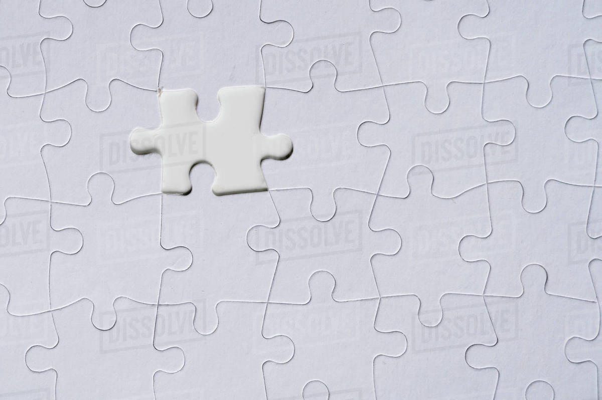 White jigsaw piece on jigsaw pattern - Royalty-free Stock Photo | Dissolve