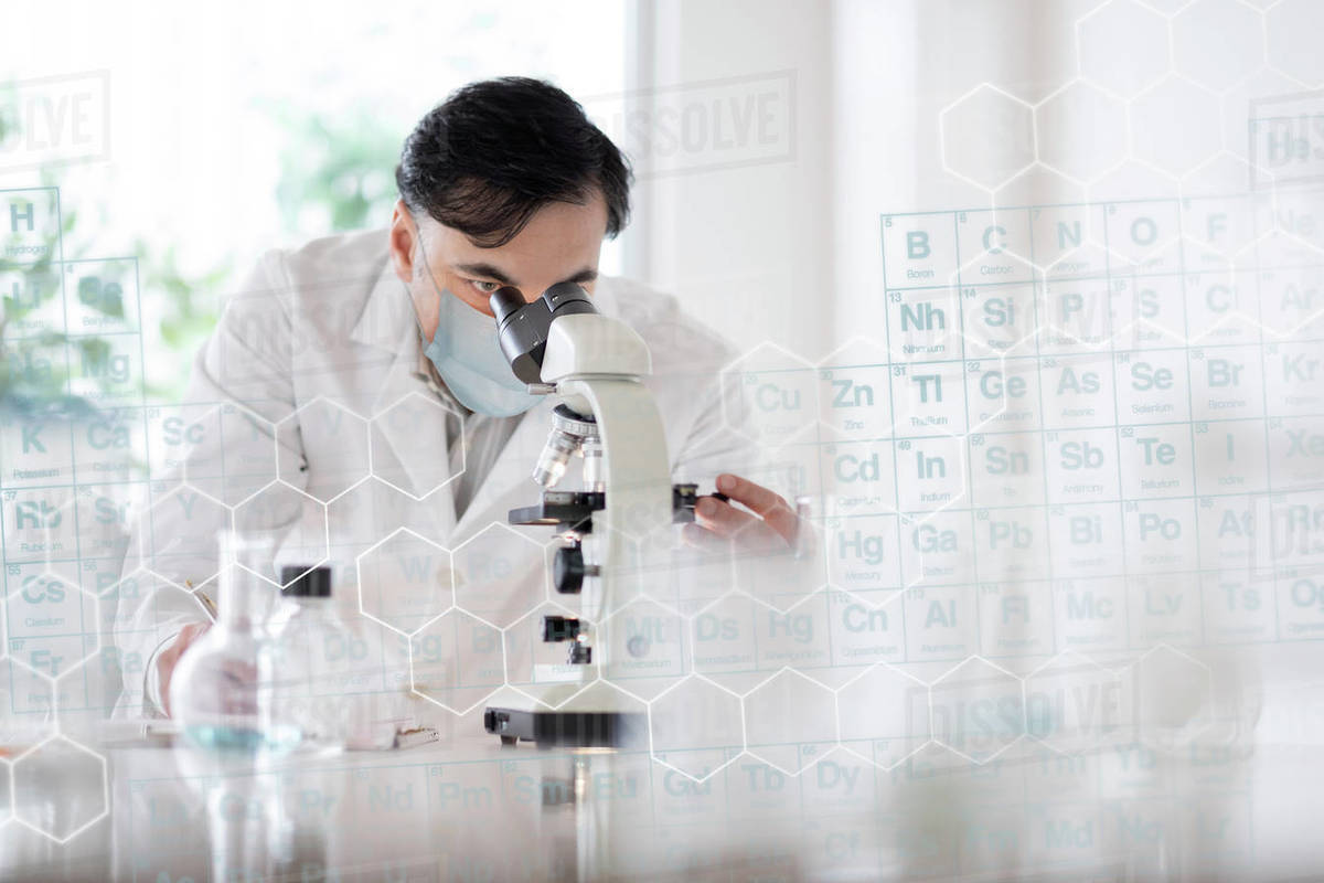 Doctor using microscope - Royalty-free Stock Photo | Dissolve