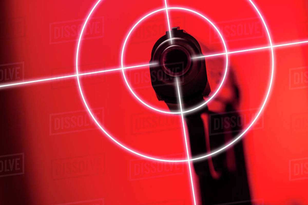 Shooting target on red background with gun - Stock Photo - Dissolve