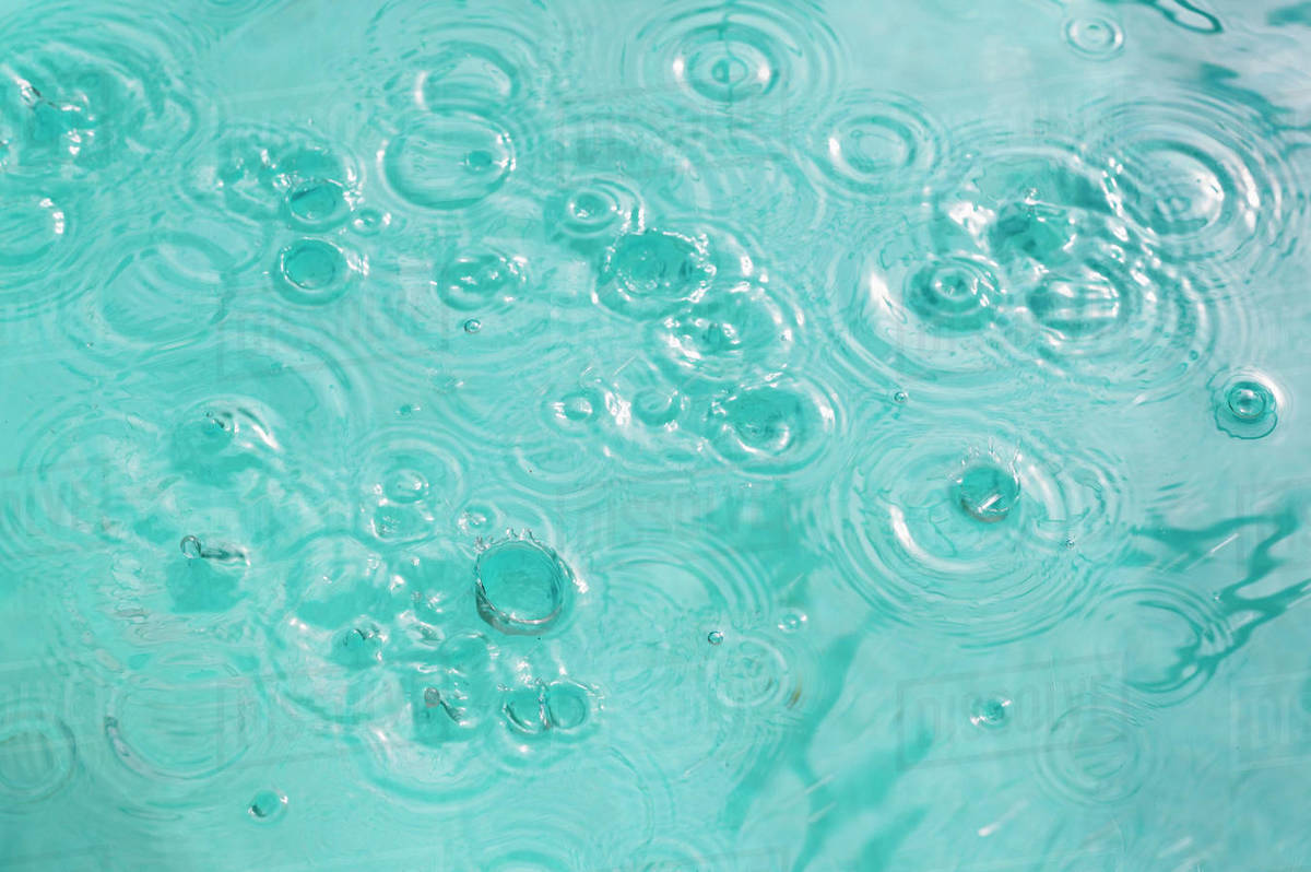 Concentric ripples on water surface - Stock Photo - Dissolve