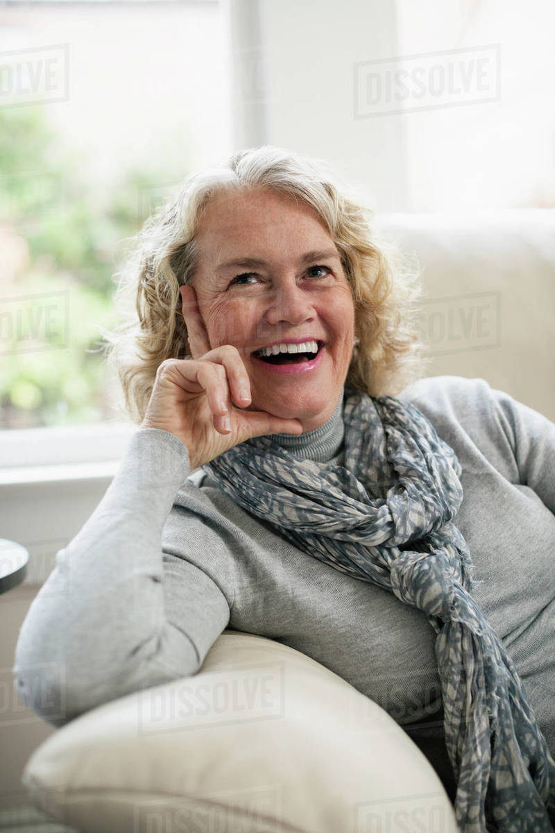 Relaxed senior woman sitting on sofa - Royalty-free Stock Photo | Dissolve