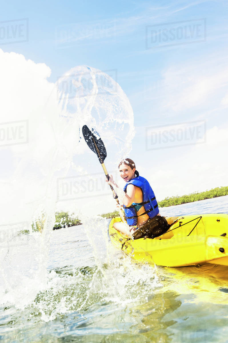Woman kayaking - Stock Photo - Dissolve