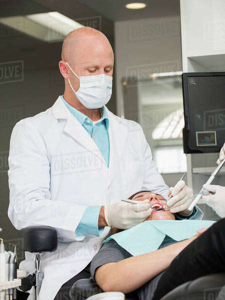 Dentist operation on patient - Royalty-free Stock Photo | Dissolve