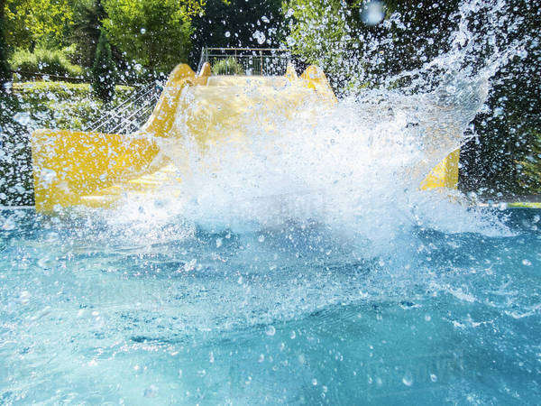 Boy (6-7) making splash in pool - Royalty-free Stock Photo | Dissolve